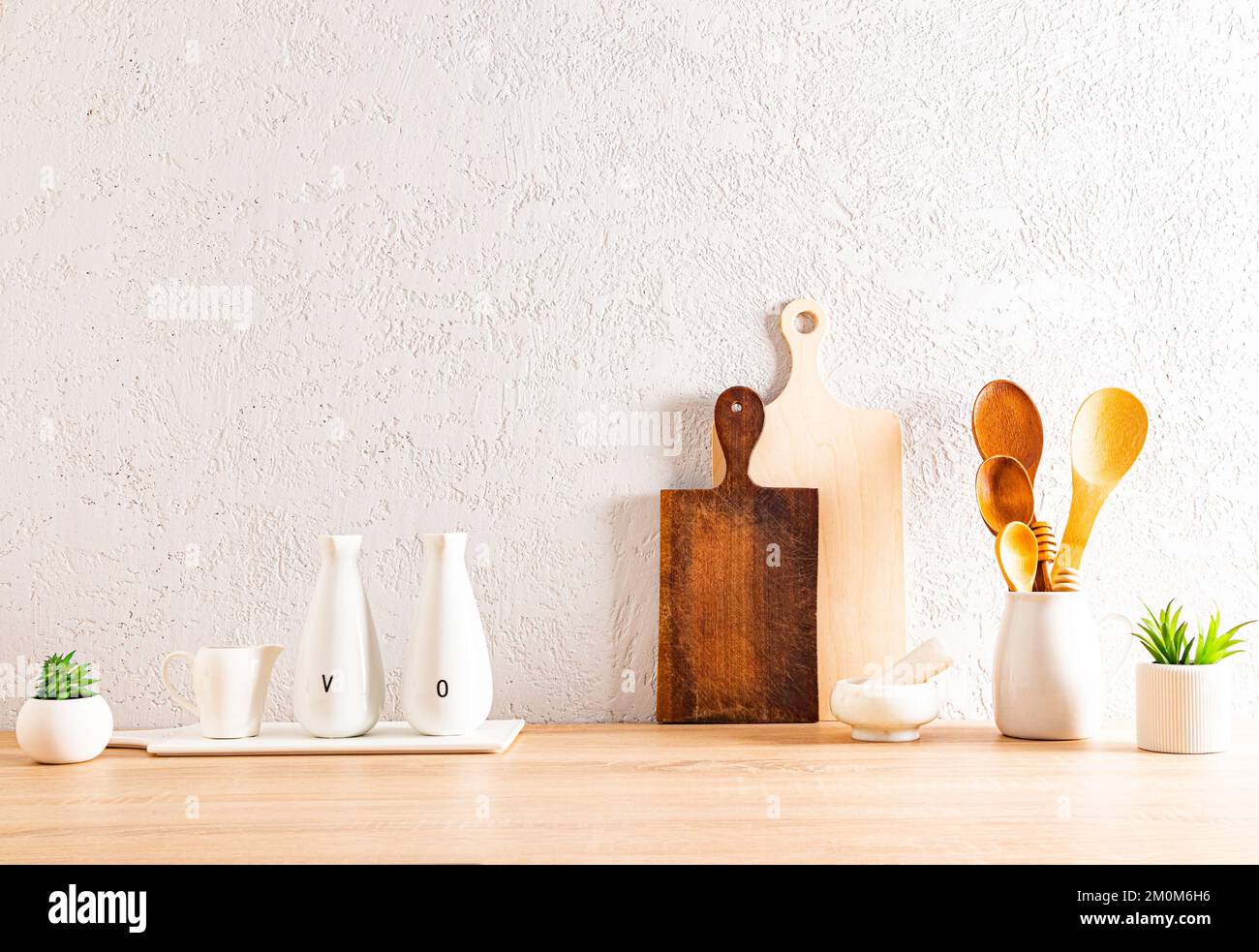modern kitchen background with utensils on a wooden countertop against ...