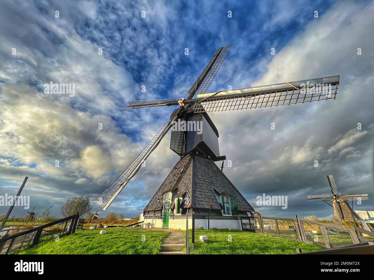 A low angle shot of a spinning historic windmill in Kinderdijk ...