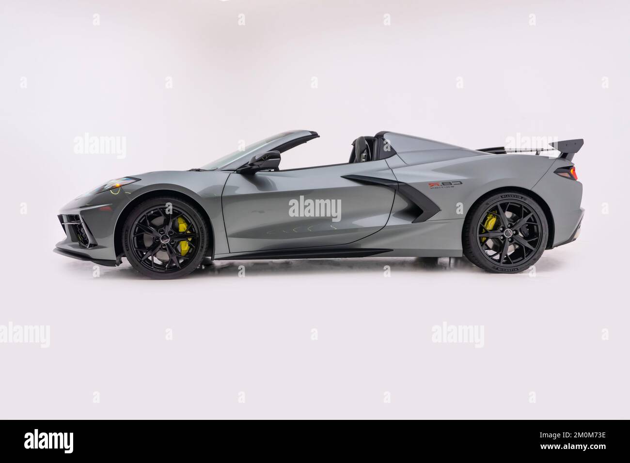 A dark-gray Corvette C8-R Edition side view in the studio, white ...