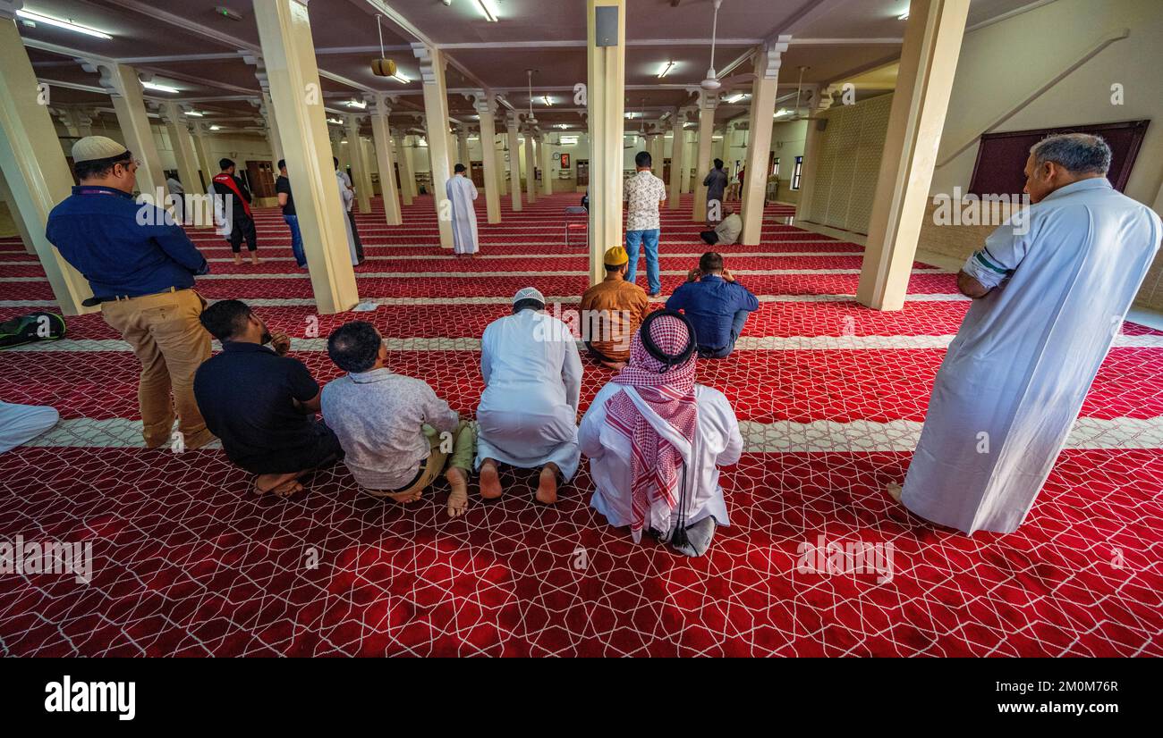 People take part in morning prayers in a mosque in Souq Waqif in Doha ...