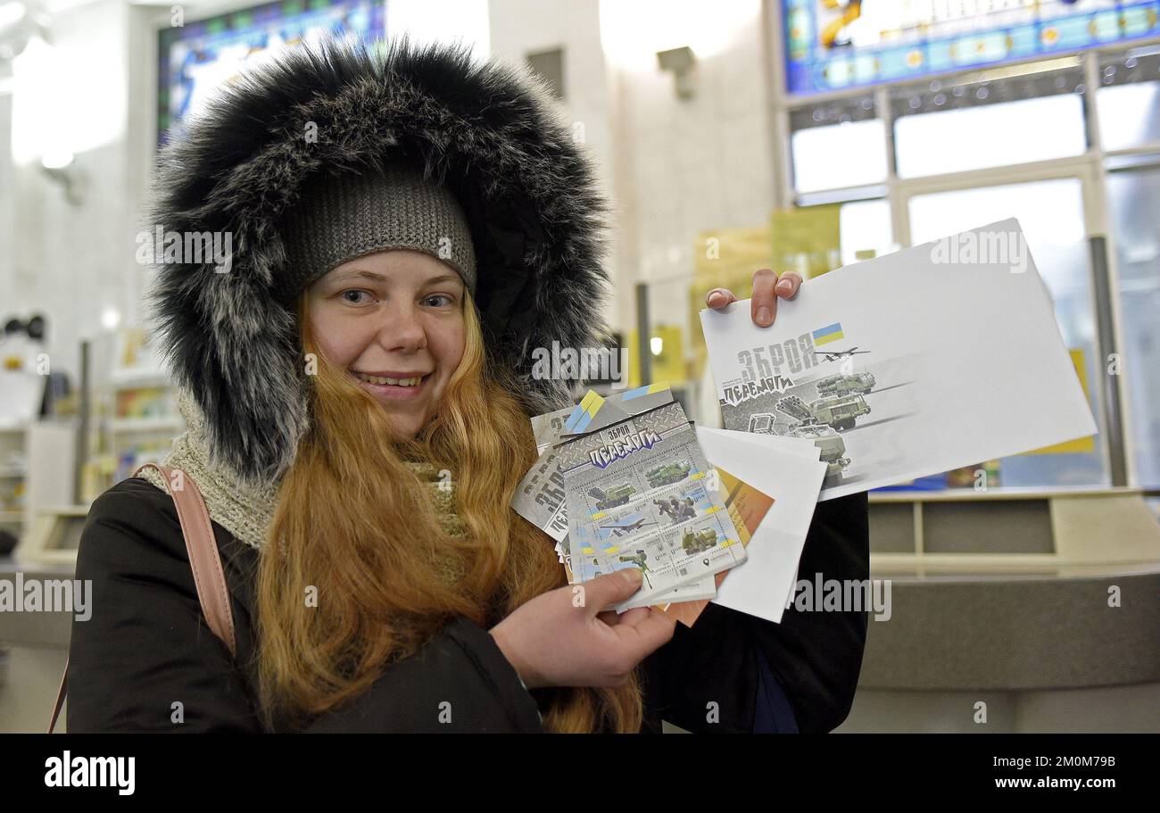KYIV, UKRAINE - DECEMBER 6, 2022 - A woman holds postage stamps and ...