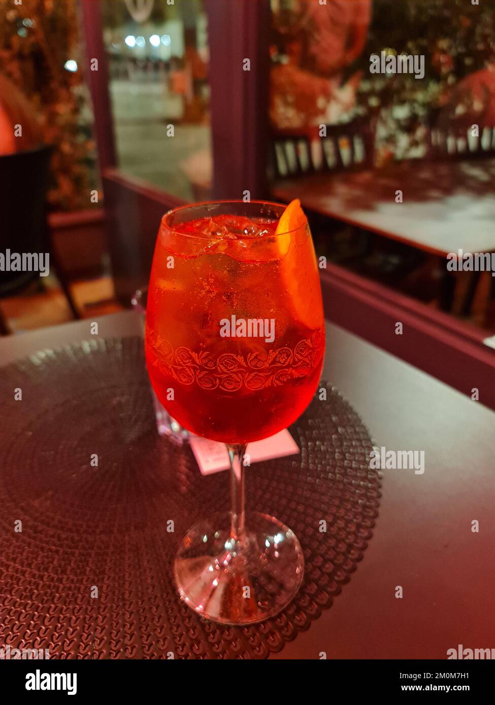 Vertical shot of refreshing glass of Spritz on the bar table, cold ...