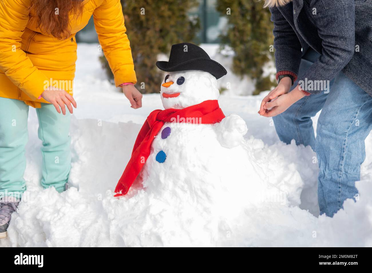 Two faceless Caucasian women are making a snowman. Winter fun Stock ...