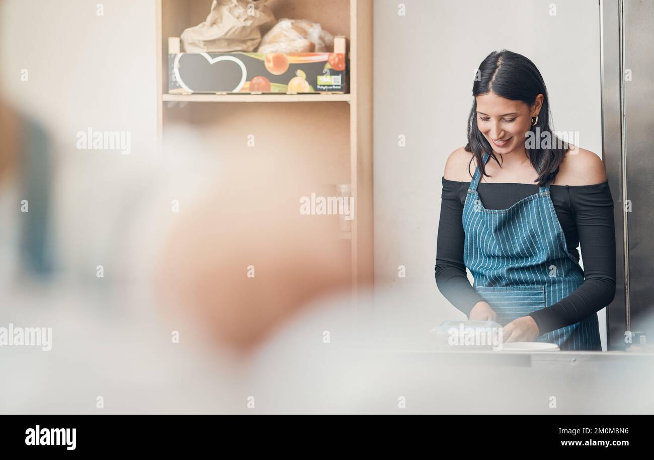 One happy young hispanic waitress working in a store or cafe. Friendly ...