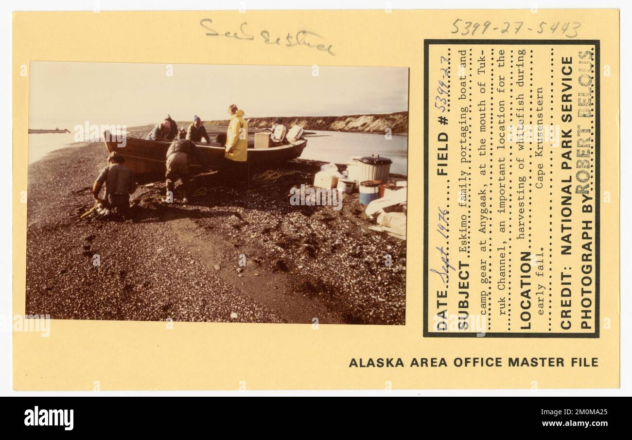 Eskimo family portaging boat and camp gear at Anygaak, at the mouth of ...