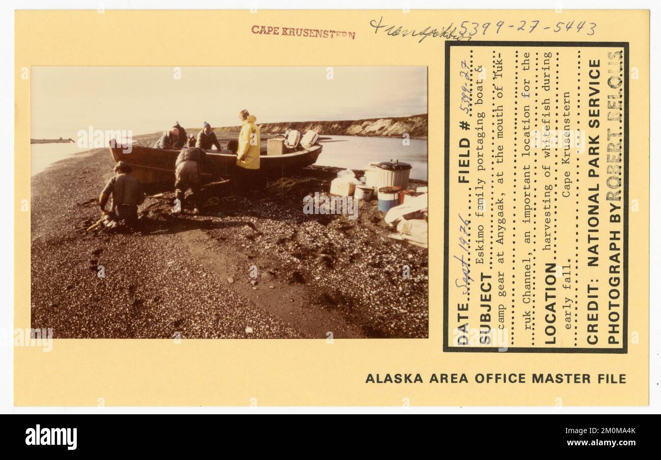 Eskimo family portaging boat and camp gear at Anygaak, at the mouth of ...