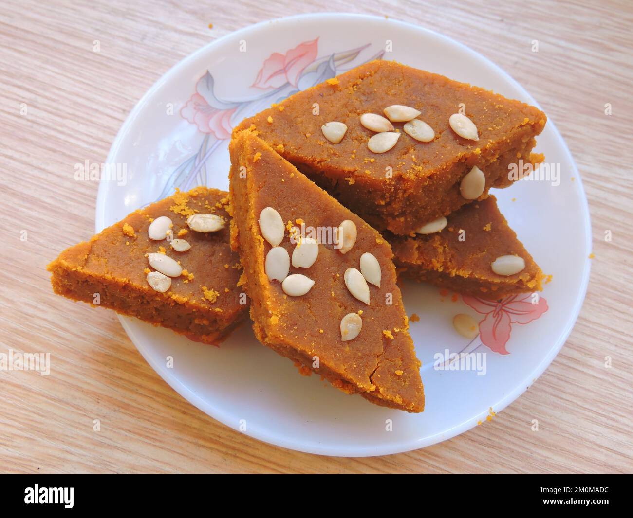 An Indian sweet called Besan barfi in local language. It is made with ...