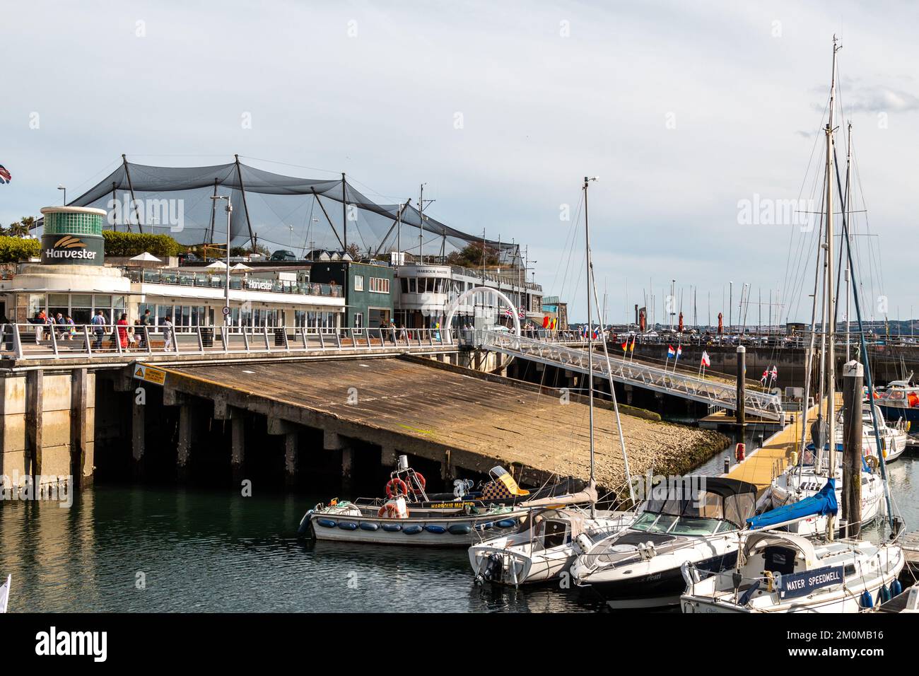 A slipway at Torquay Harbour next to the Harvester restaurant, Devon ...