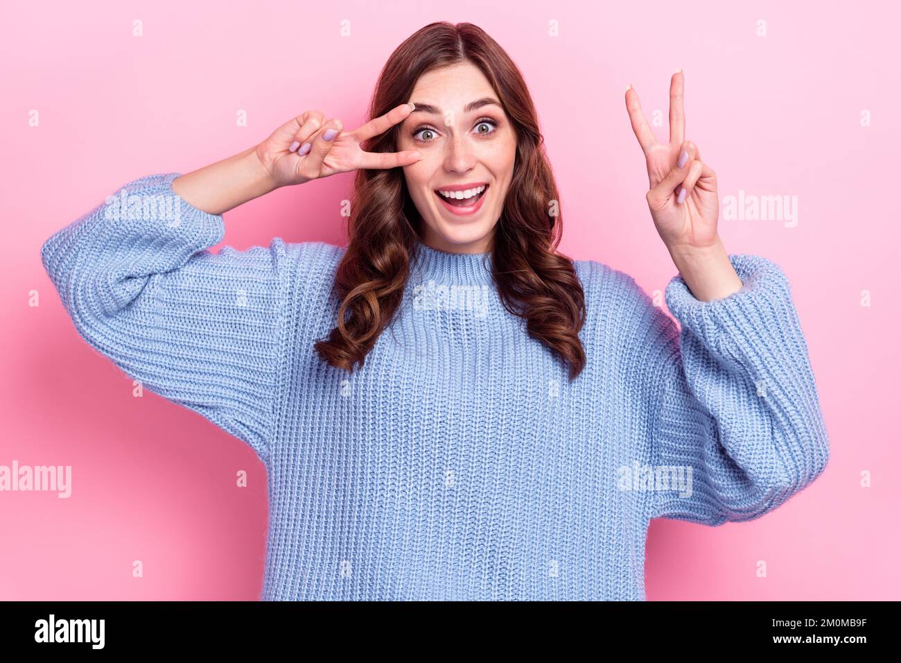 Portrait of overjoyed cheerful lady toothy smile hands fingers show v ...