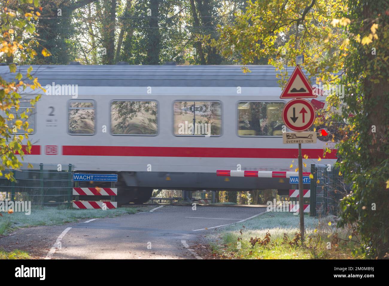 closed railroad crossing with a train passing by on high speed Stock ...