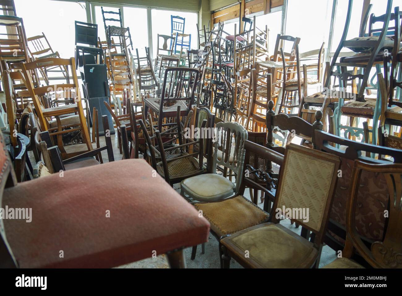 Old discarded furniture in the interior of an abandoned building ...