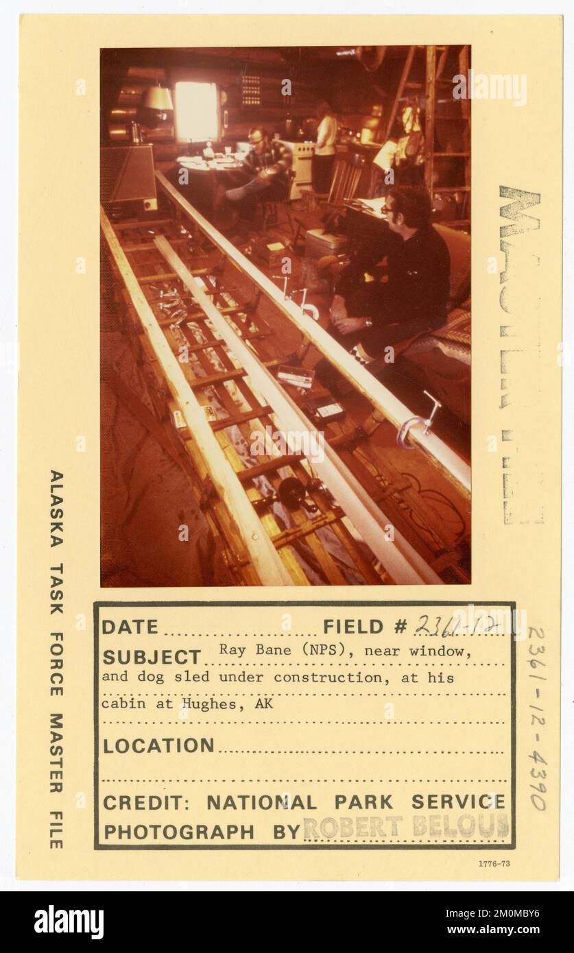 Ray Bane (NPS), near window, and dog sled under construction, at his ...