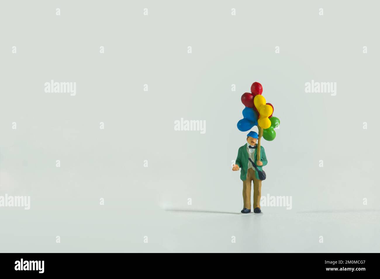 A close-up shot of a miniature figurine of a man with air balloons ...