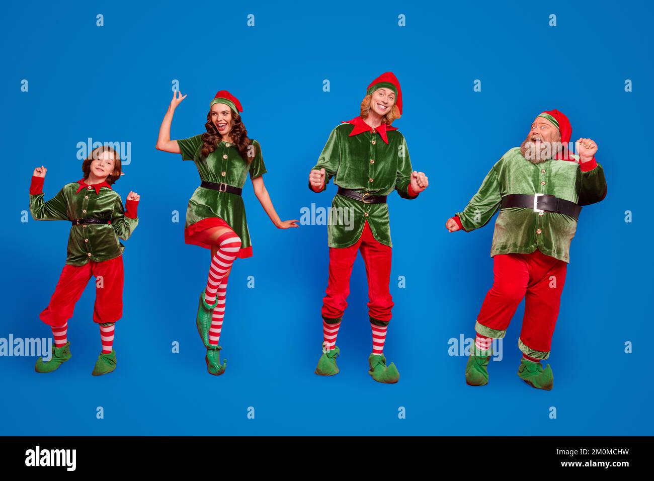 Full length photo of happy, elf people dance celebrate xmas wear hat ...