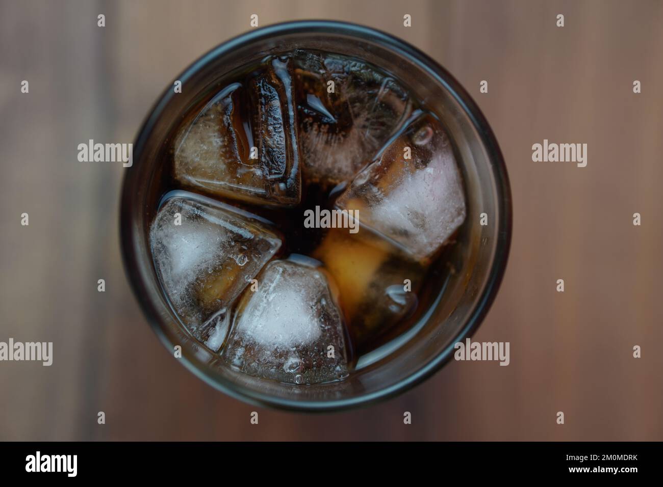 Glass of cola with ice. Top view on wood background Stock Photo - Alamy