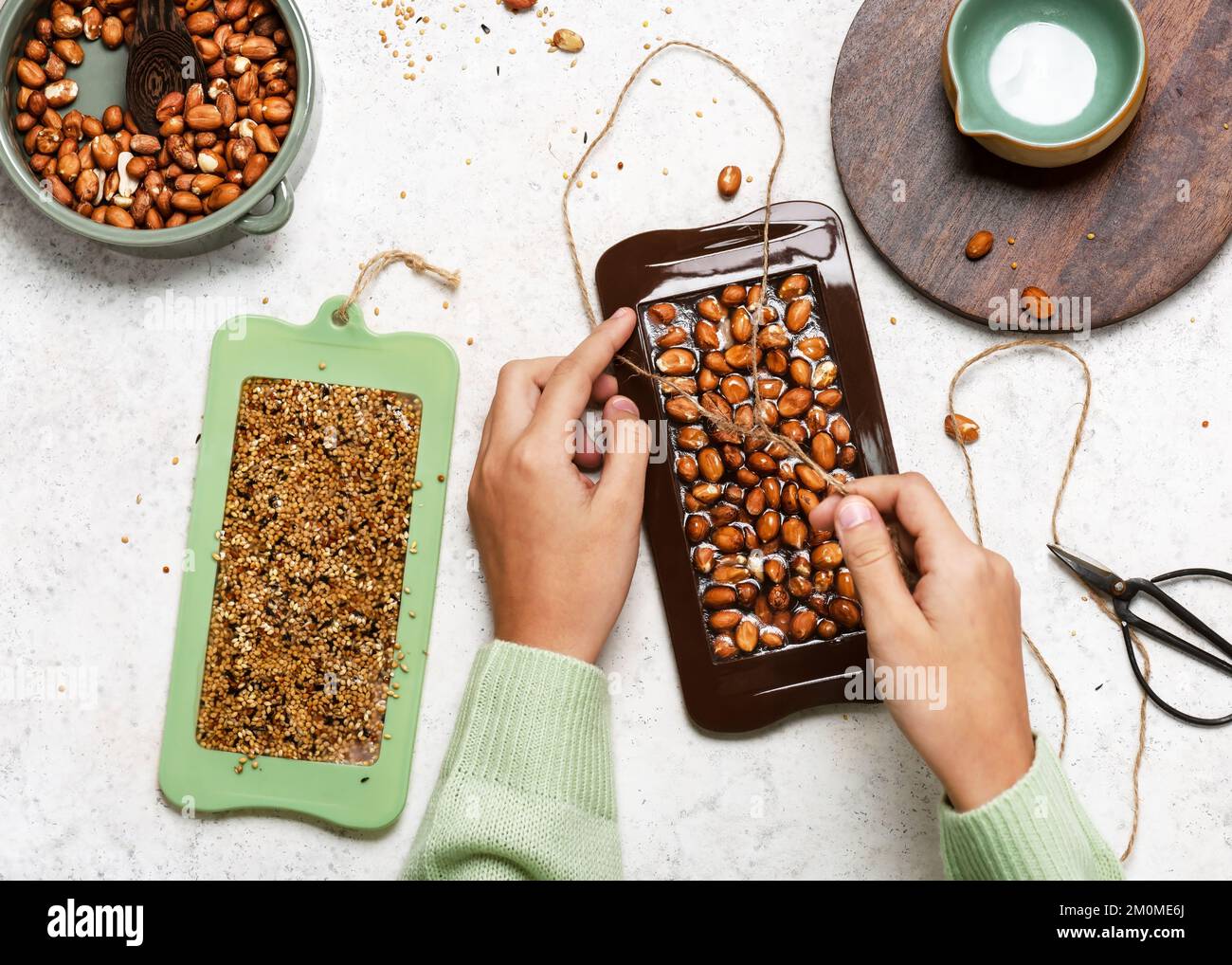 Step 3. Threading the ribbon, string, or twine in each chocolate bars ...