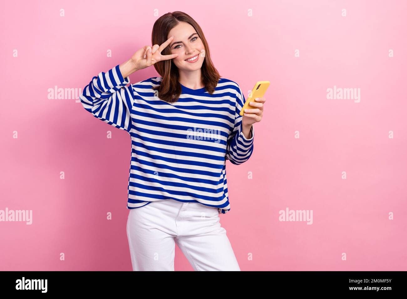 Photo of positive lovely lady addicted user wear stylish clothes v-sign ...