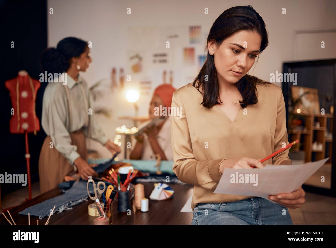 Fashion, designer and planning with woman in studio workshop for ...