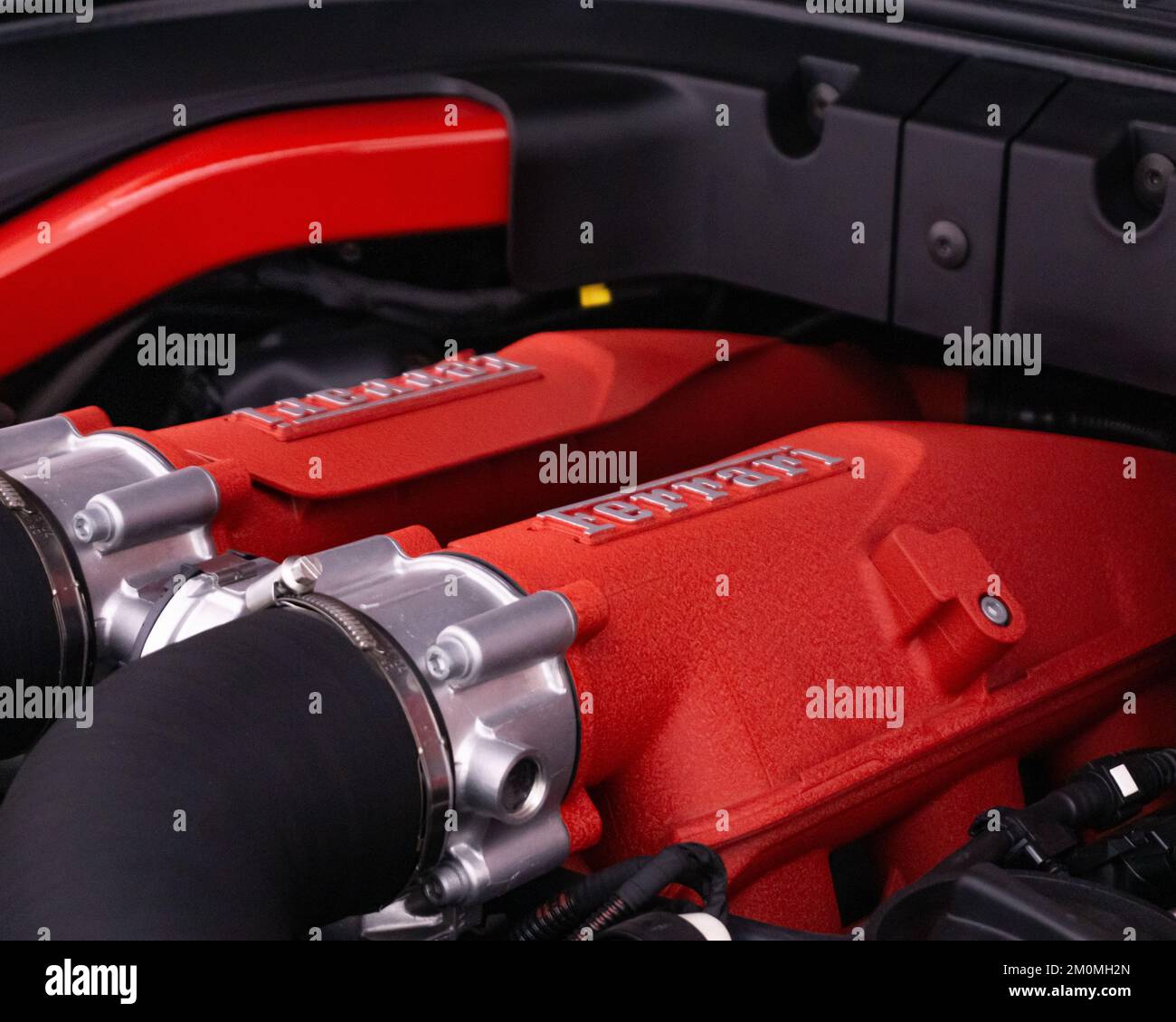 A closeup of Ferrari Portofino engine bay, red engine cover with ...