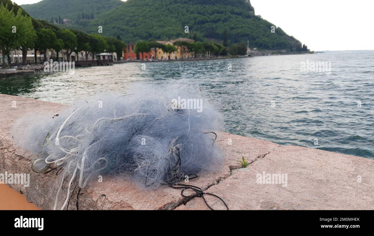 the fishing net tangled with the lake in the background Stock Photo - Alamy