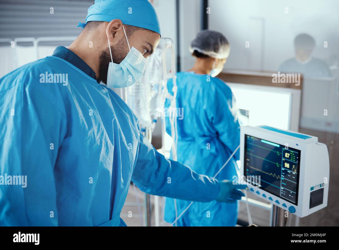 Doctor, hospital and medical machine with monitor screen during surgery ...