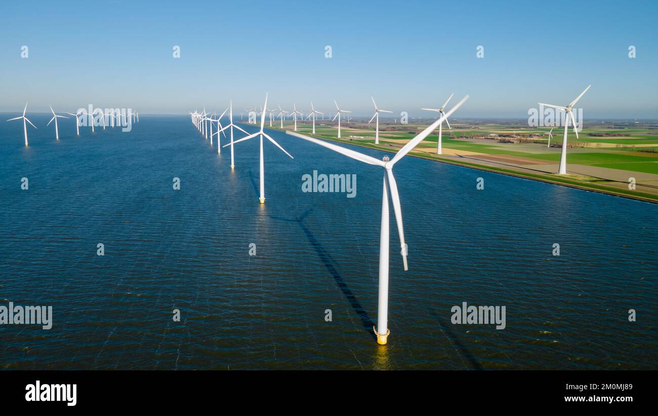 Windmill park with wind mill turbines generating electricity with a ...