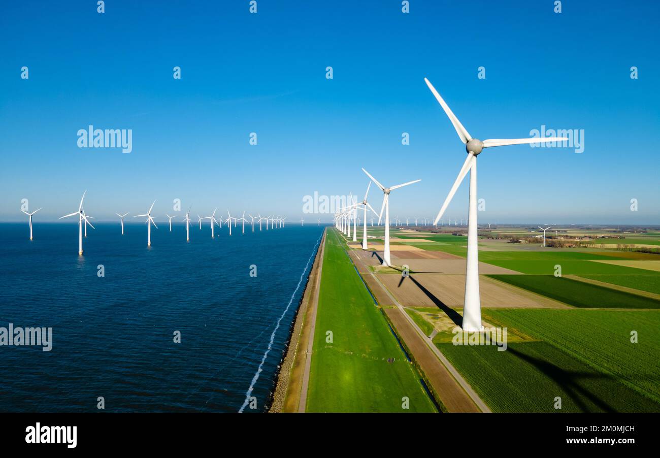 Windmill park with wind mill turbines generating electricity with a ...