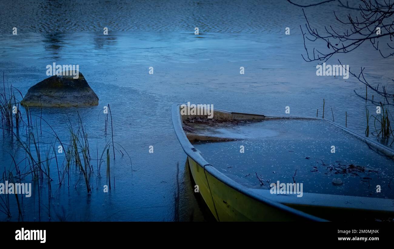 Rowing boat frozen in the ice Stock Photo - Alamy
