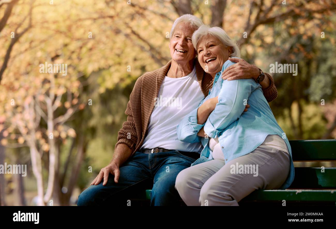 Senior couple, park bench and happy while sitting together in ...