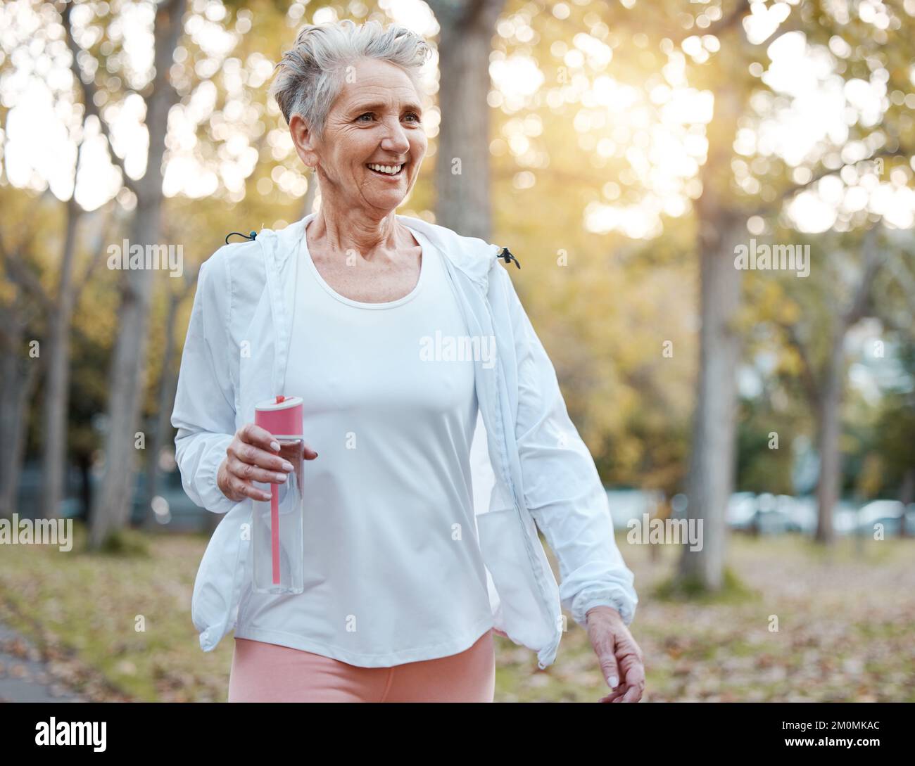 Fitness, nature and senior woman with water bottle for wellness ...