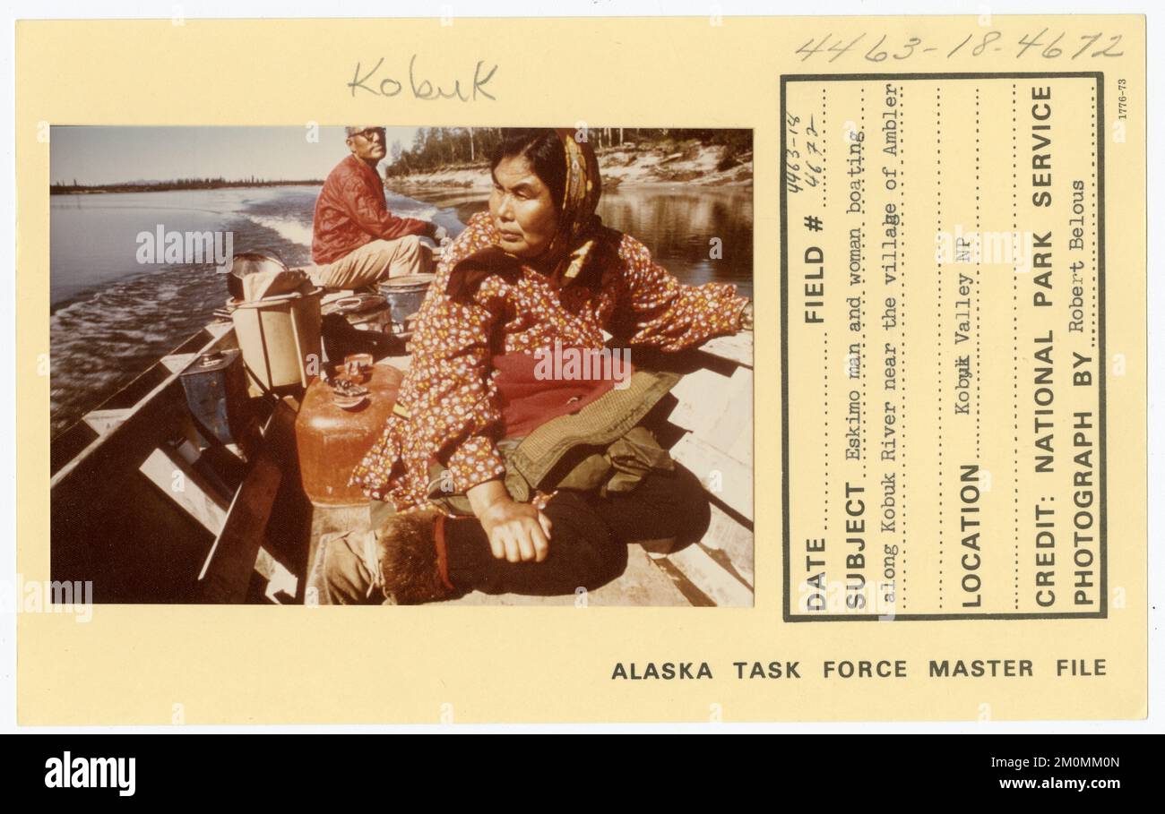 Eskimo man and woman boating along Kobuk River near the village of ...