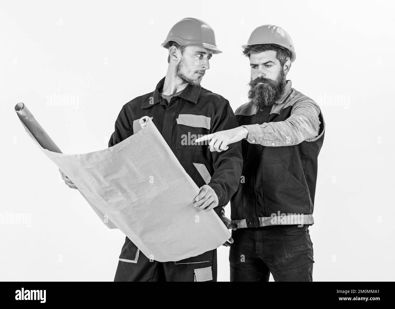 Architect and build concept. Men in helmets with blueprint Stock Photo ...