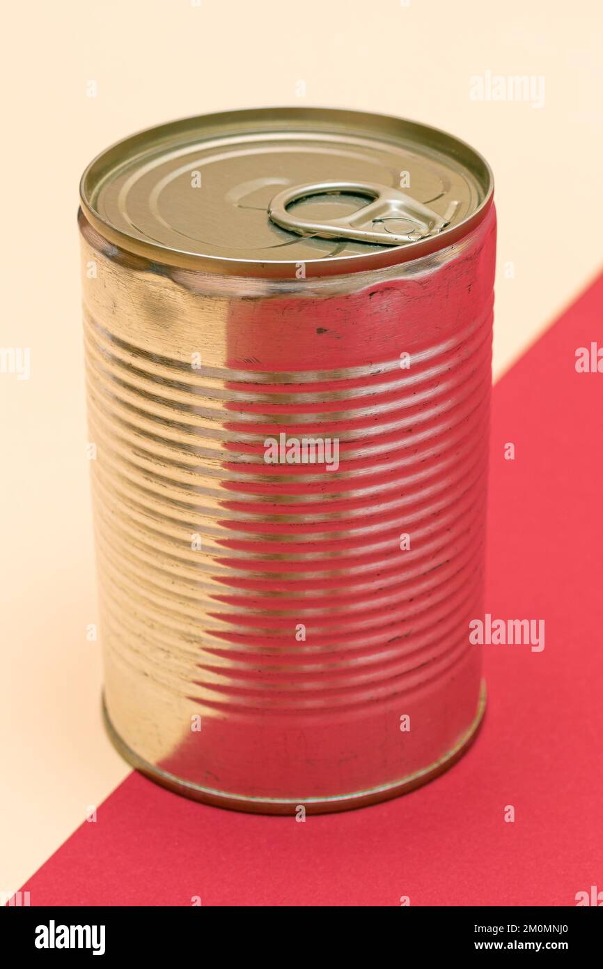 Unopened Tin Can with Blank Edge on Split Red and Beige Background ...