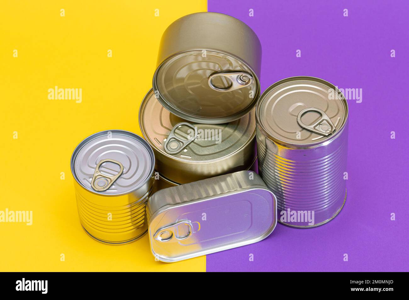 A Group of Stacked Tin Cans with Blank Edges on Split Yellow and Violet ...