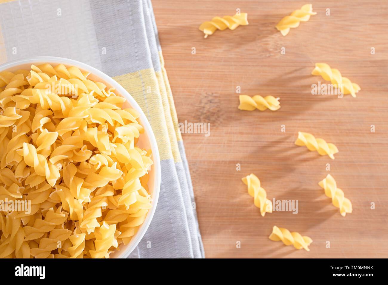 Uncooked Fusilli Pasta in White Bowl on Wooden Board. Raw and Dry ...