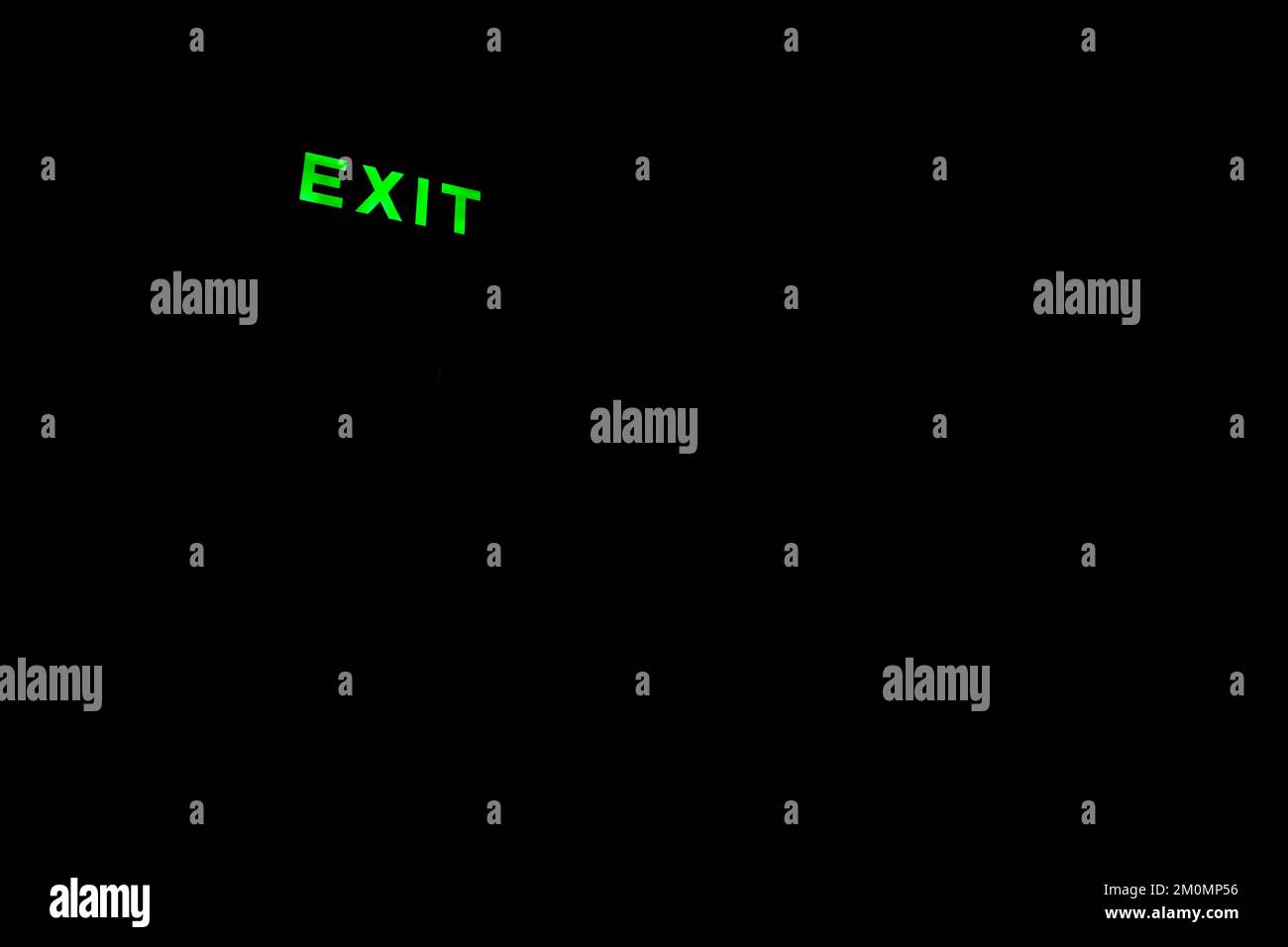 green neon exit panel with light on a dark background on black Stock ...