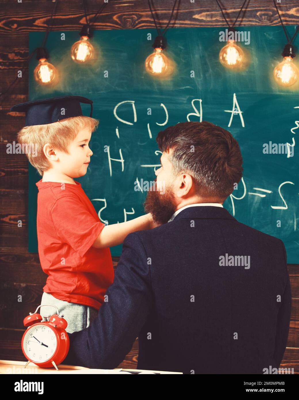 Prodigy child concept. Boy, child in graduate cap discussing scribbles ...