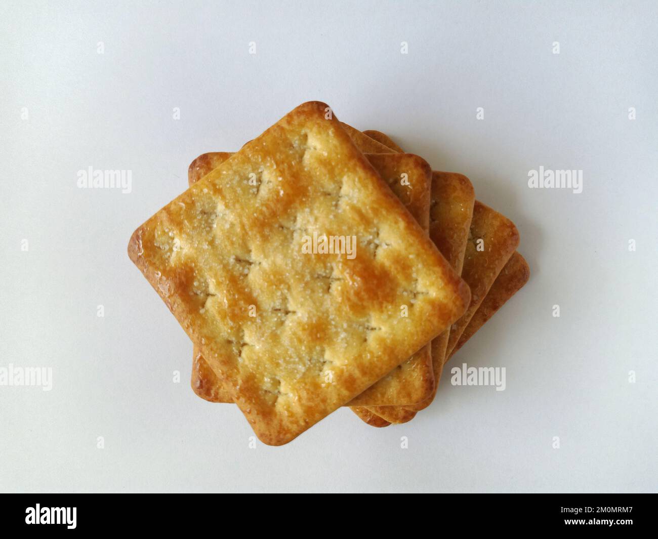 top view of piles of sugar-coated sweet crackers on white background ...