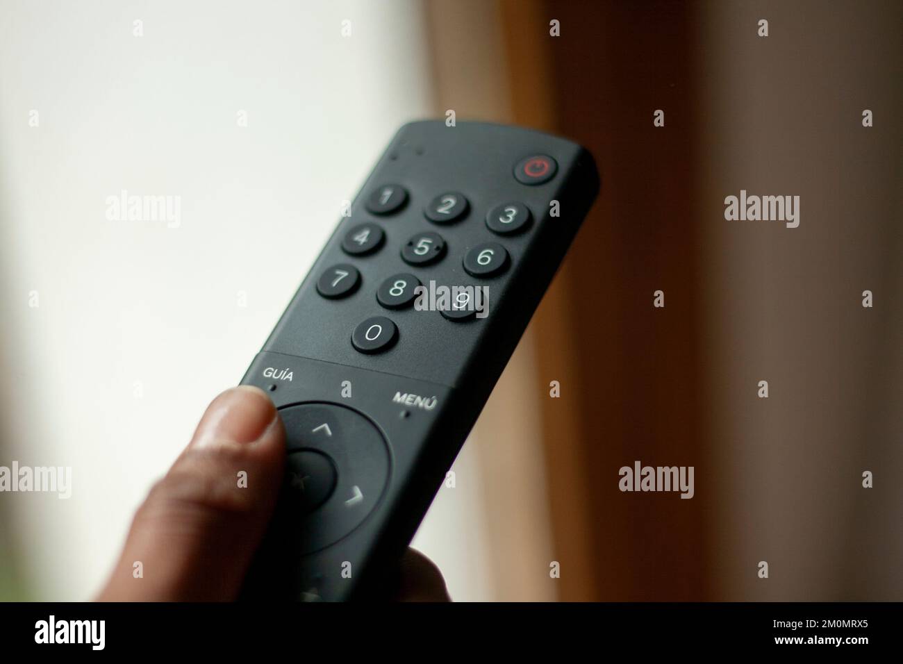 hand directing a television remote where you can see the different ...