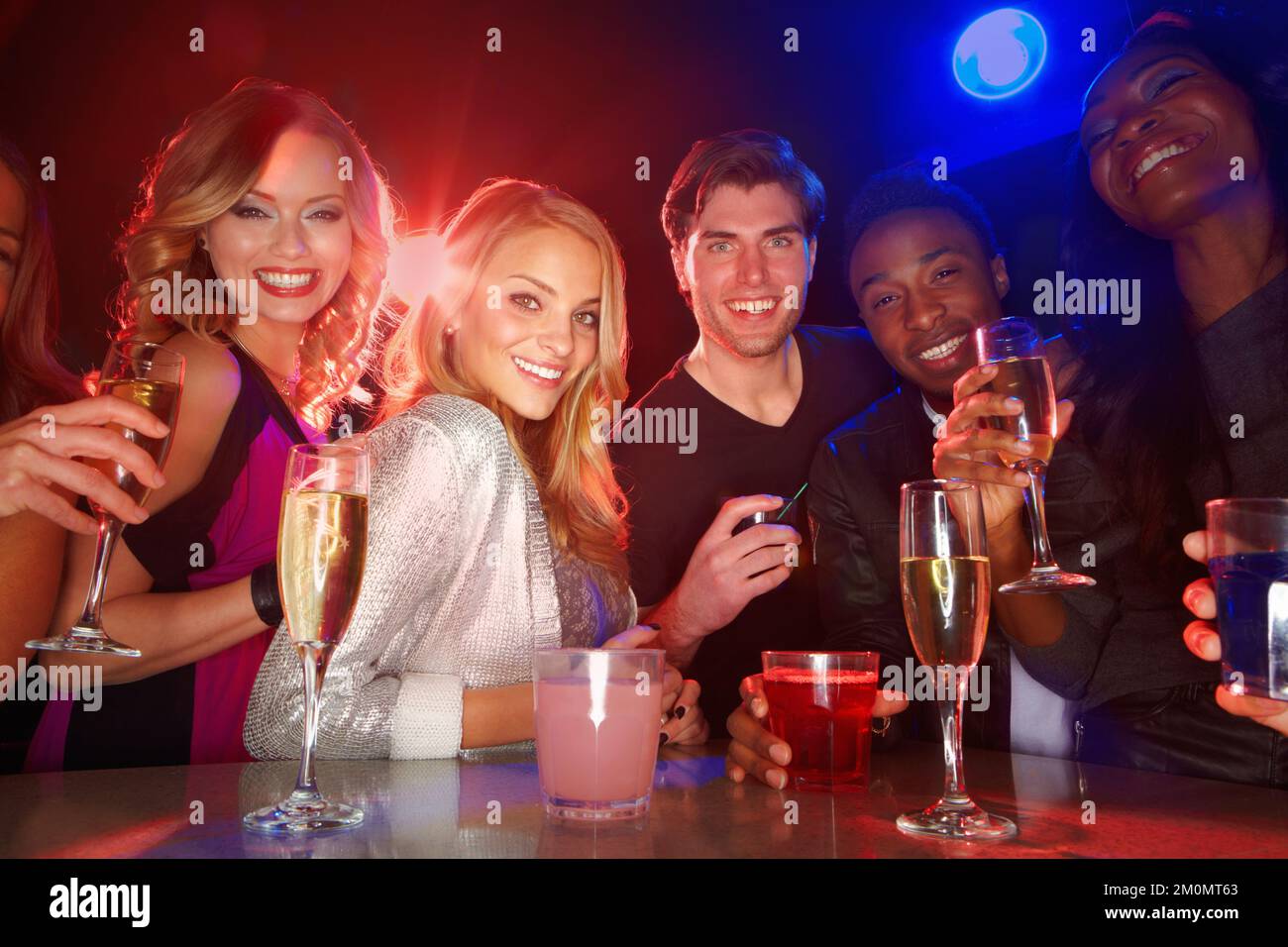 Portrait, clubbing and drinking with friends together in a nightclub ...