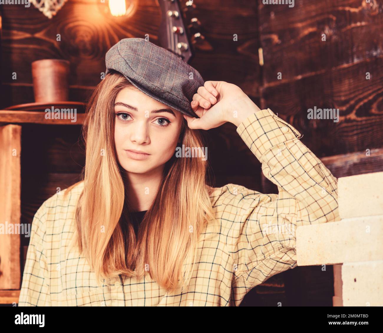 Girl in casual outfit with kepi in wooden vintage interior. Girl tomboy ...