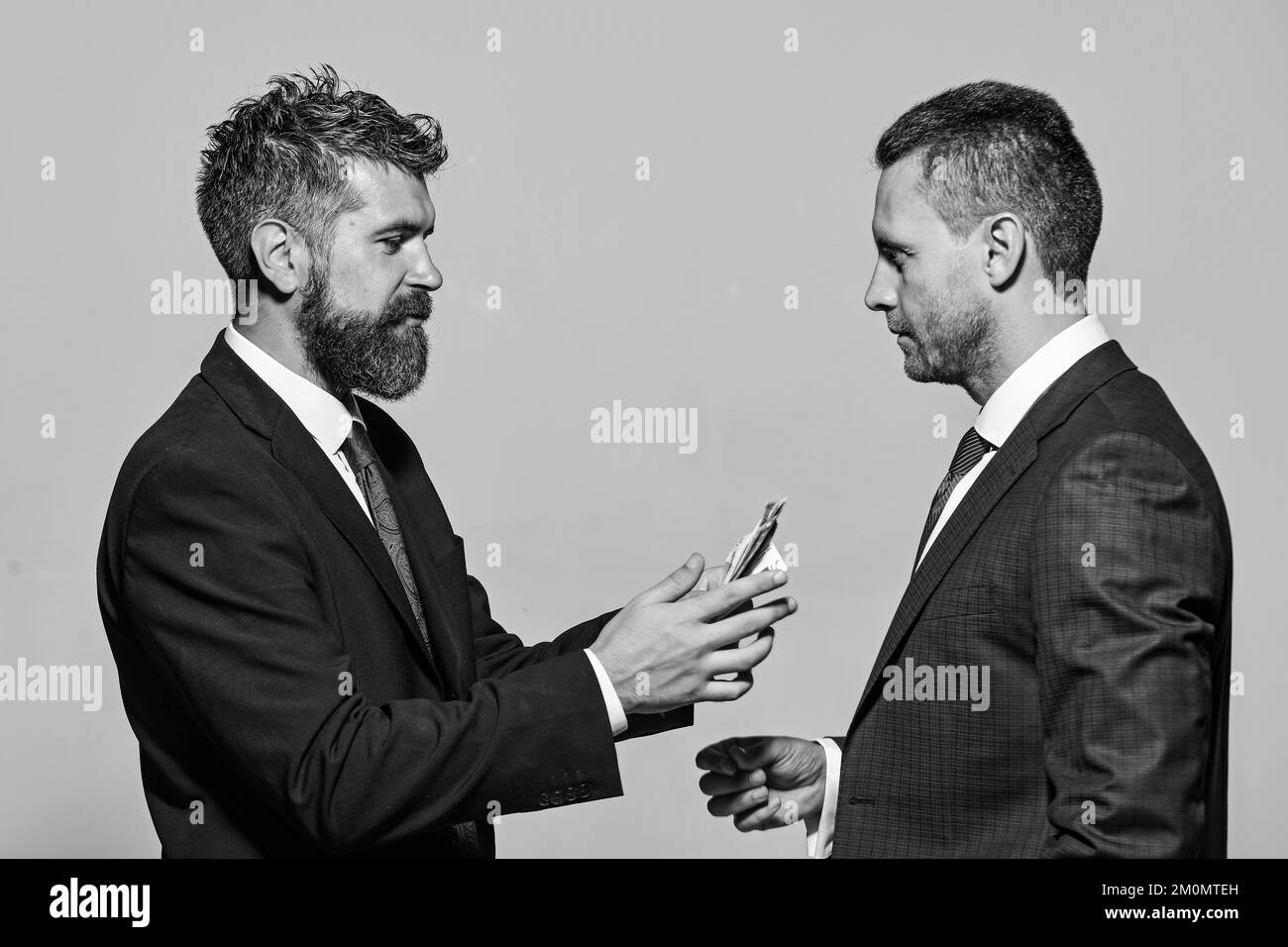 Businessmen with busy faces in formal suits on grey background Stock ...