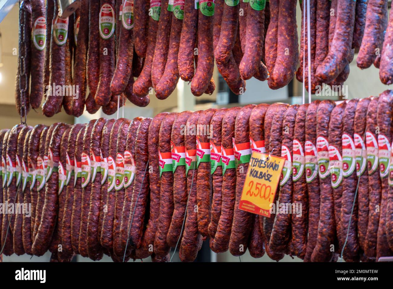 A closeup shot of Hungarian salami hanging in the Central Hall Market ...