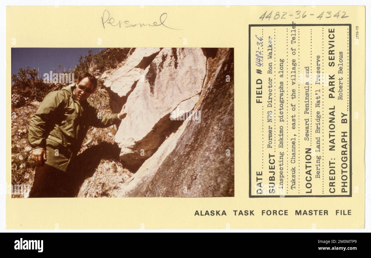 Former NPS Director Ron Walker inspecting Eskimo pictographs along ...