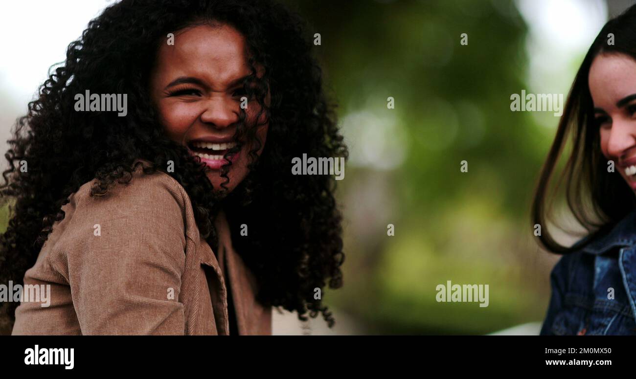 Two friends laughing together, Candid diverse young women real life ...