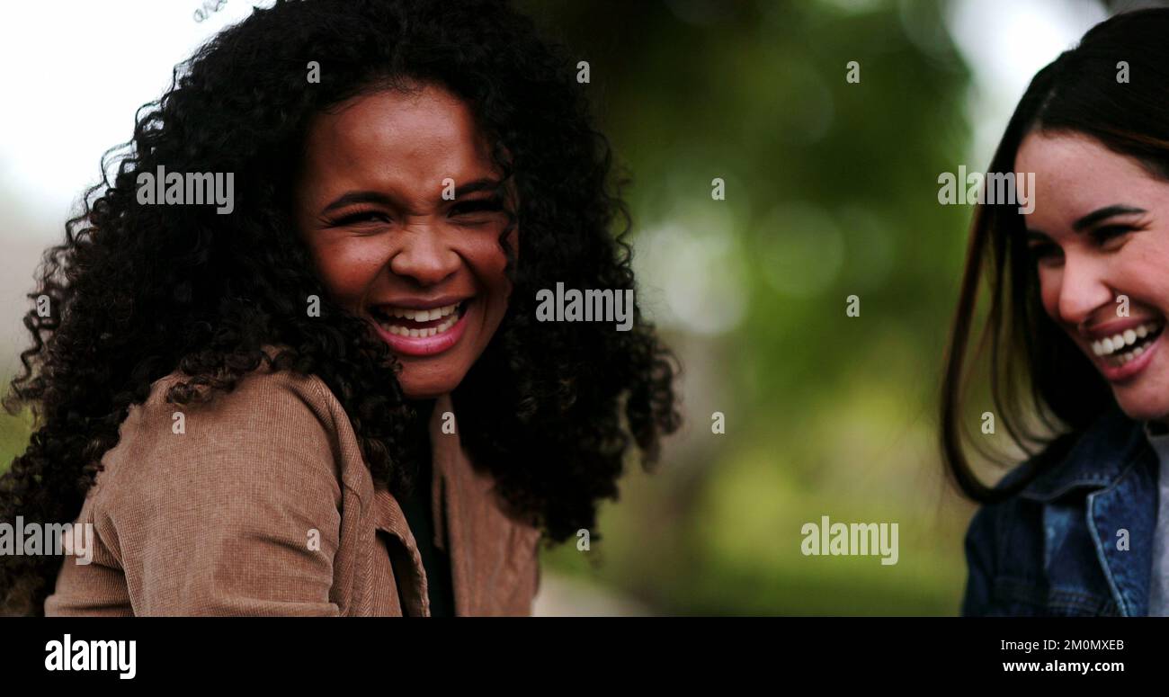 Two friends laughing together, Candid diverse young women real life ...
