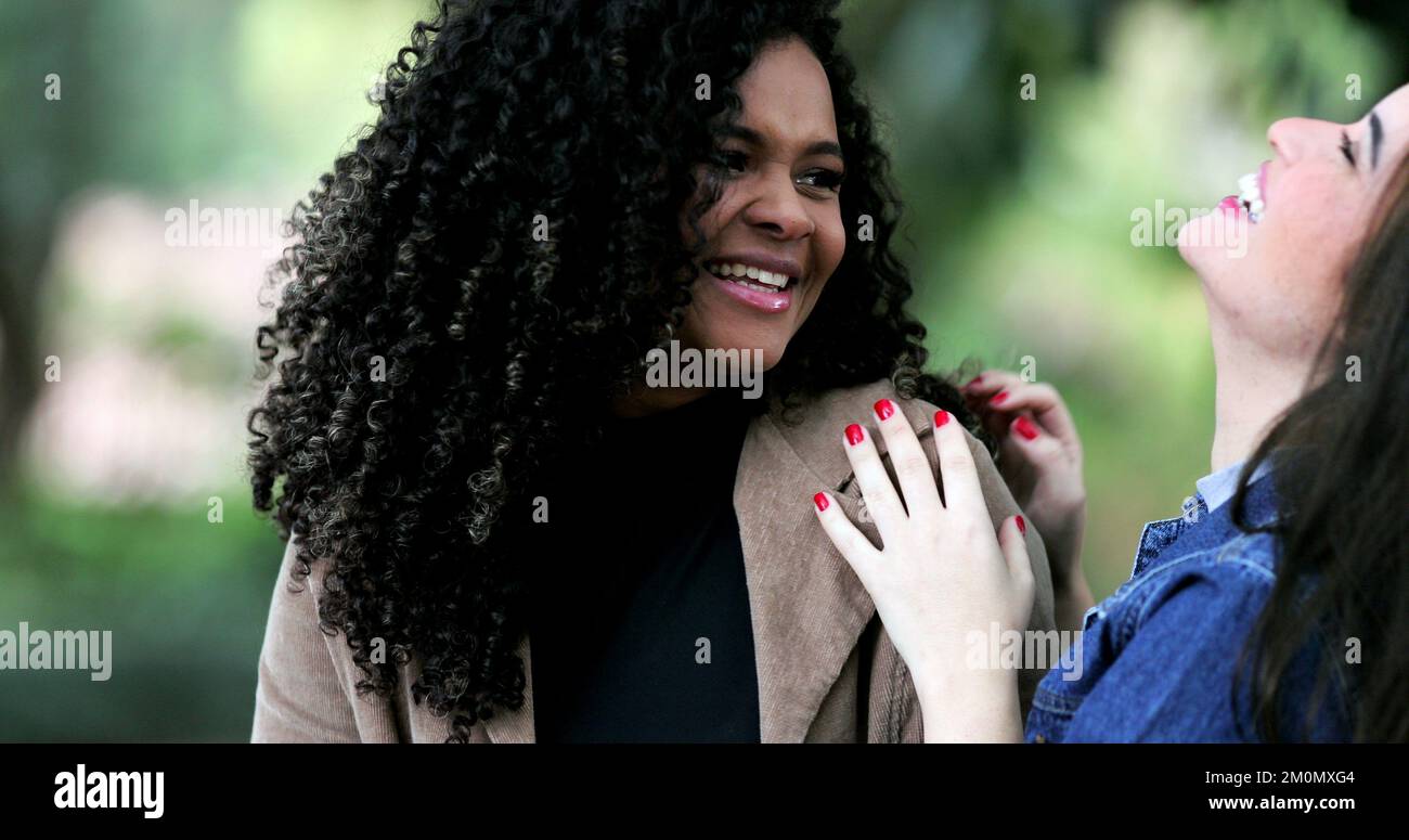 Two girls telling gossip secret. Woman real life laugh reaction Stock ...