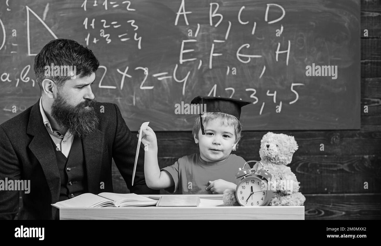 Kid happy studies individually with father, at home. Individual ...