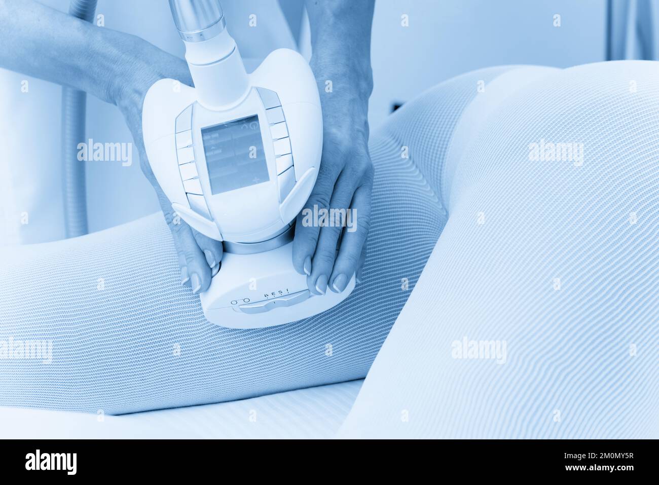 Woman in special white suit getting anti cellulite massage for legs in ...