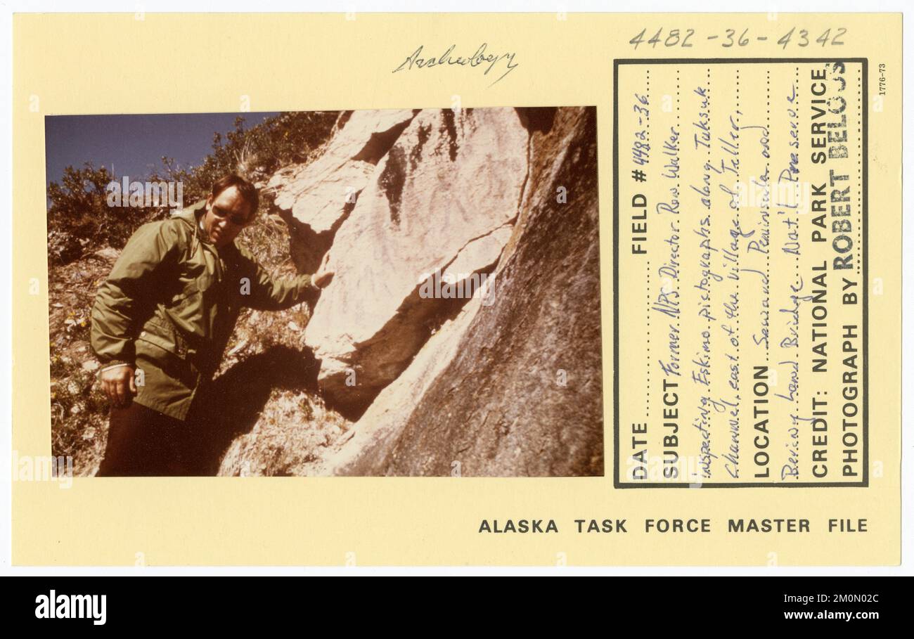 Former NPS Director Ron Walker inspecting Eskimo pictographs along ...